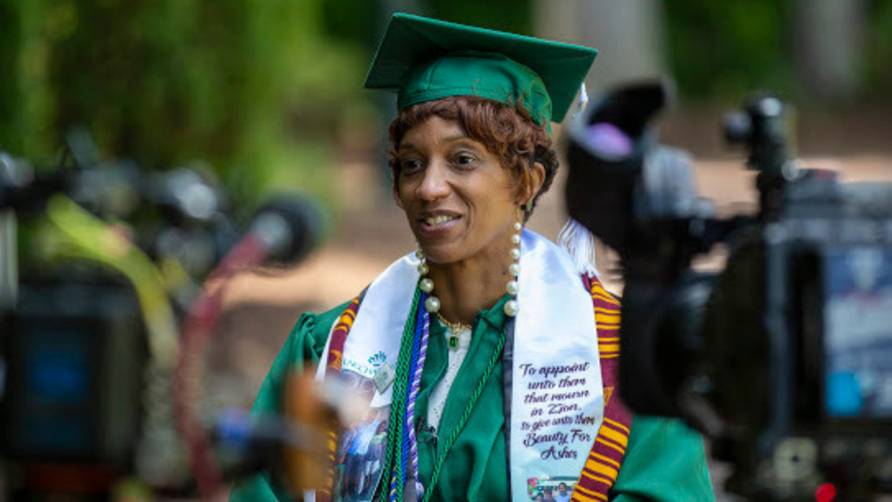 NICU Mom Graduates from College Wearing Hand to Hold Sash - Hand to Hold
